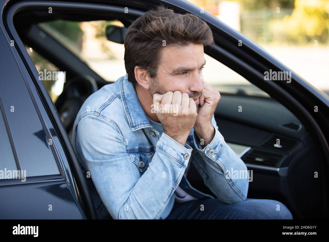 a man thinking beside of a car Stock Photo - Alamy