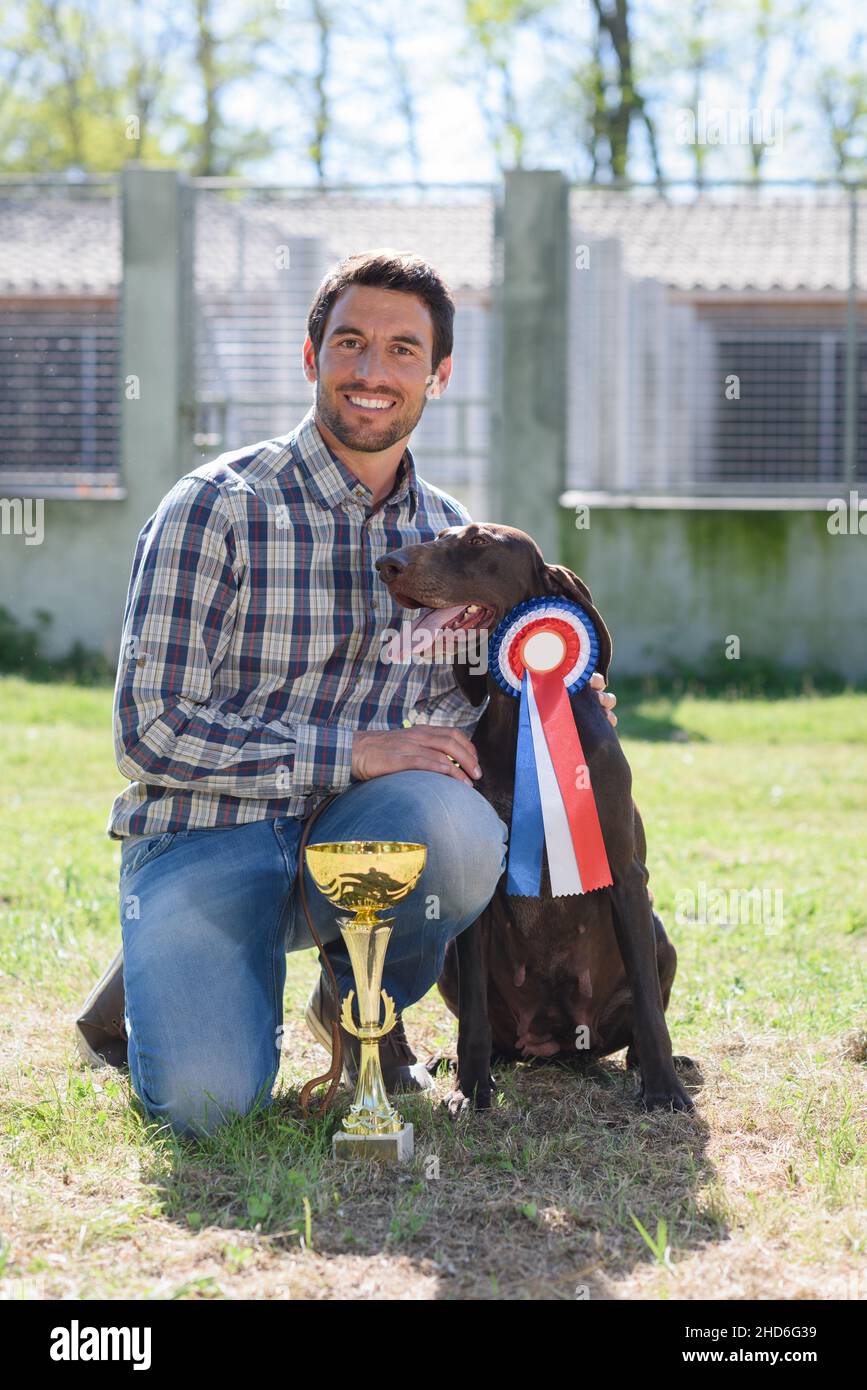 breeder posing with his dog Stock Photo - Alamy