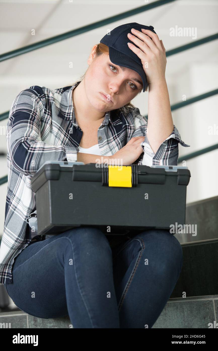 sad female electrician with toolbox Stock Photo - Alamy