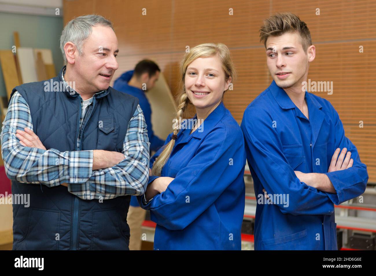 group of apprentices in overall posing Stock Photo - Alamy