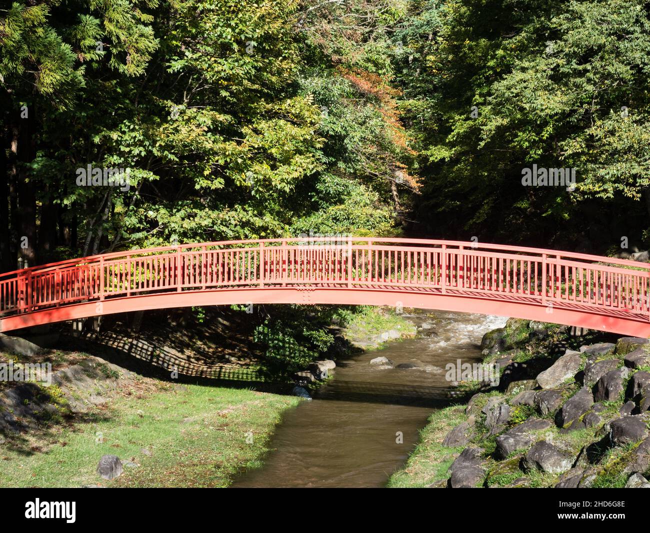 Red bridge across the Togawa river leading to Manji Stone Buddha in ...