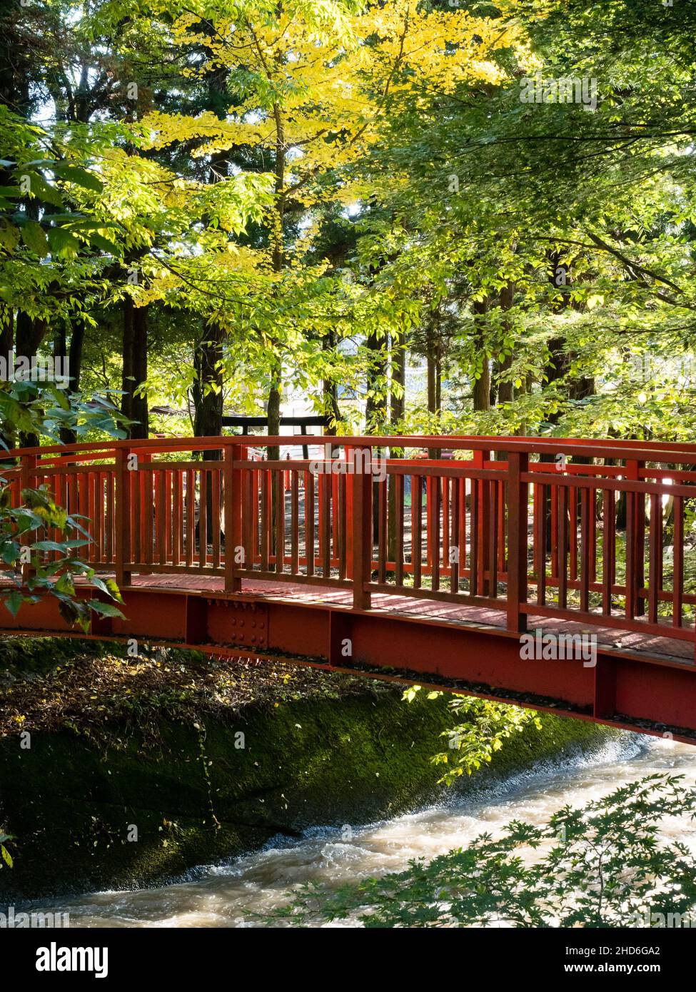 Red bridge across the Togawa river leading to Manji Stone Buddha in ...