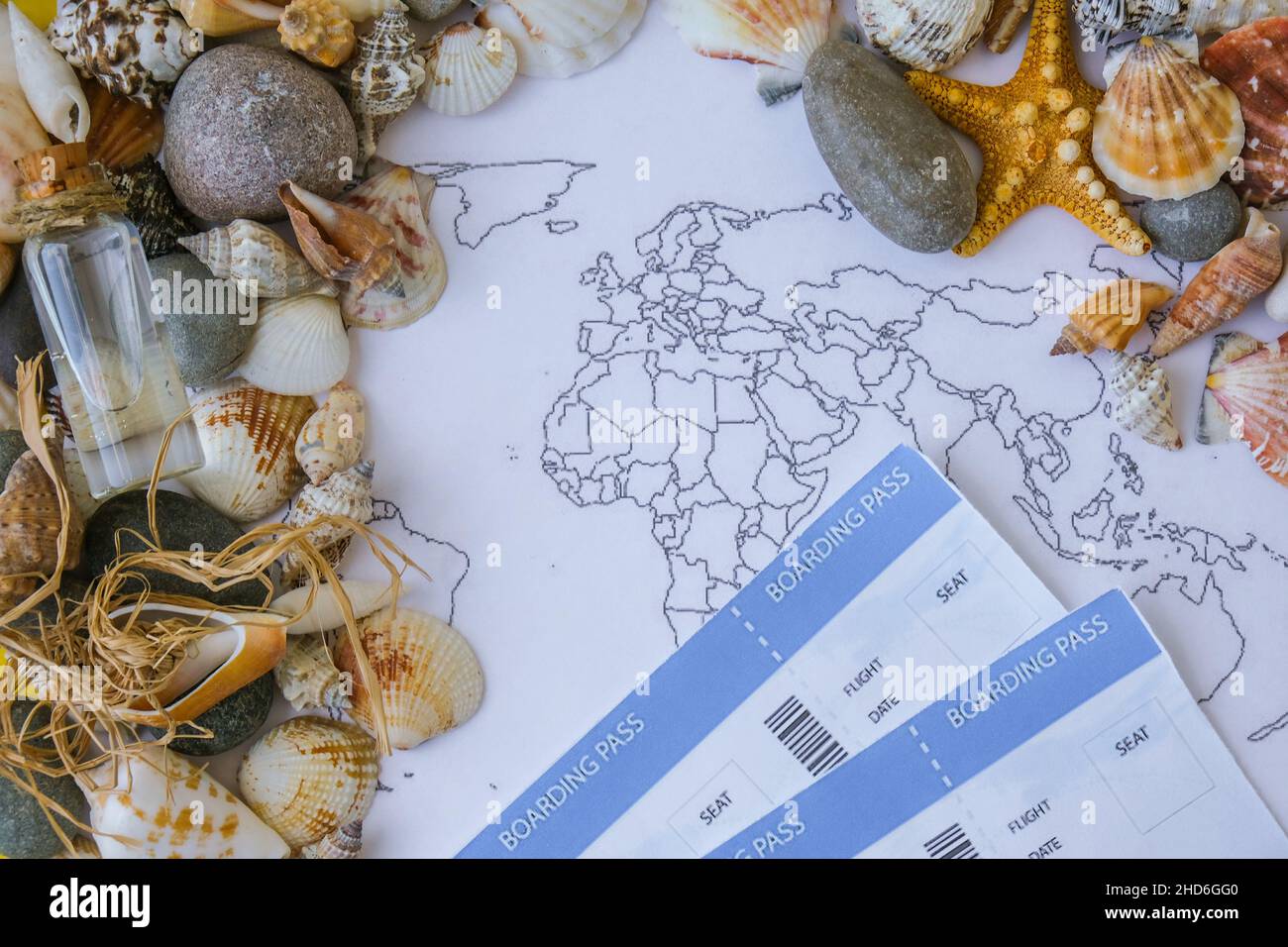 World map, seashells and pebbles boarding pass. Travel vacation concept ...