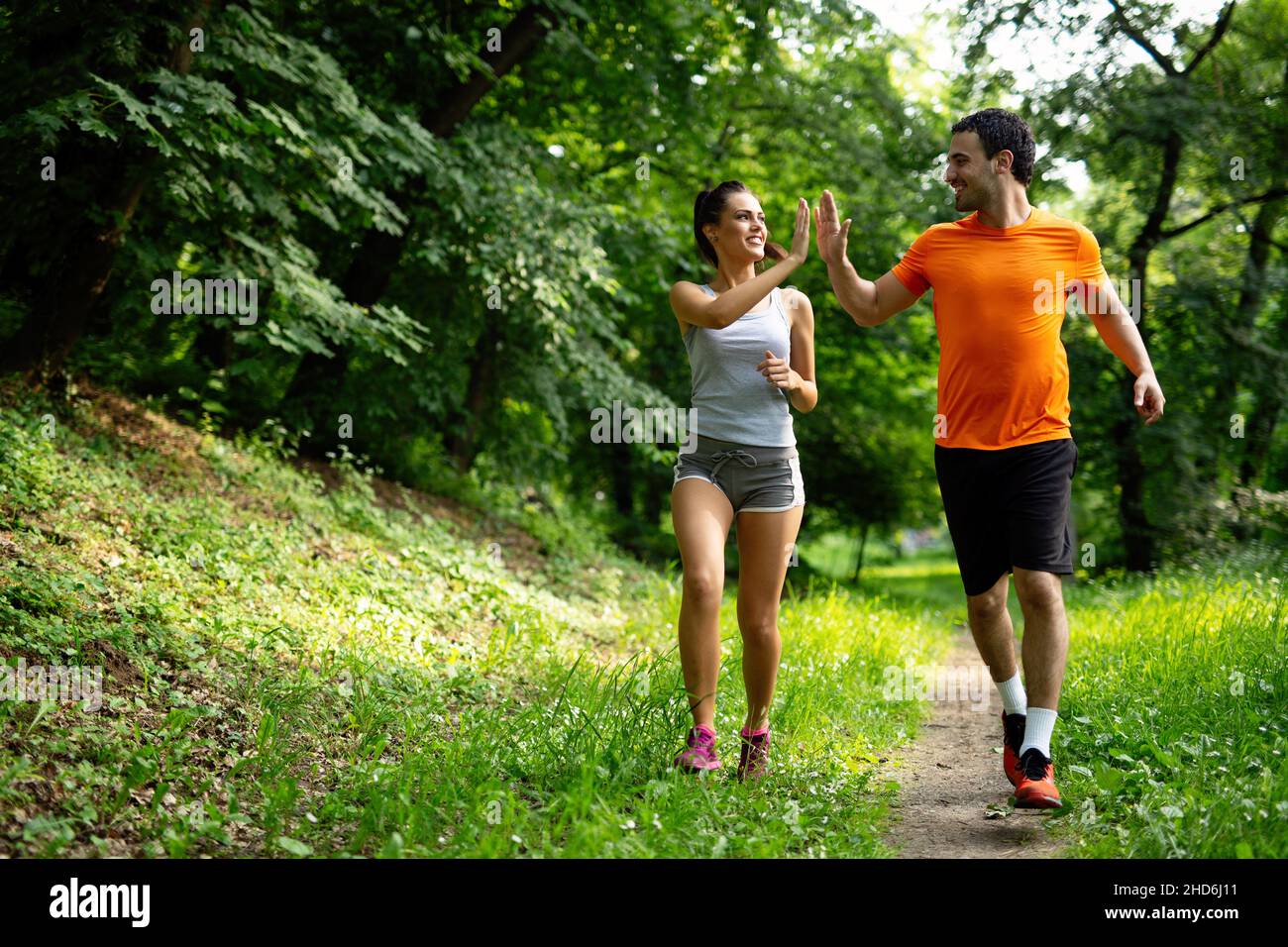 Portrait of happy fit people running together ourdoors. Couple sport ...