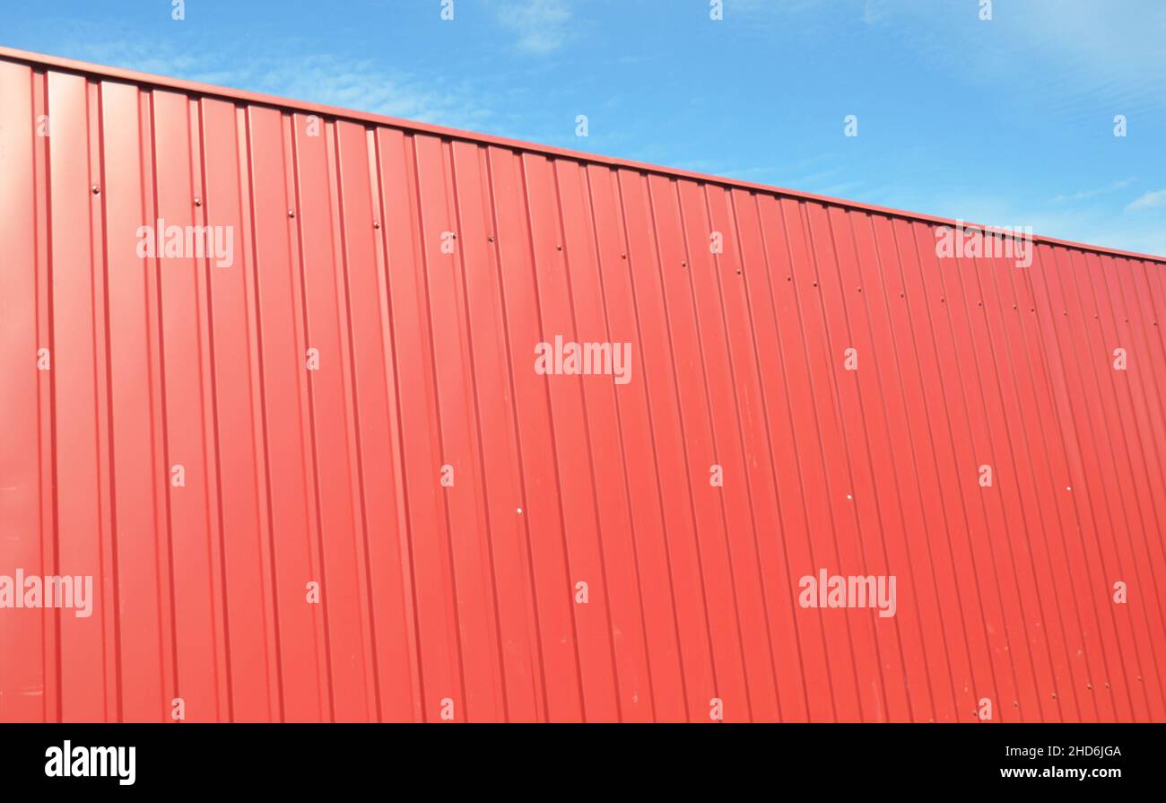 A high red privacy fence from metal profile fence panels Stock Photo ...