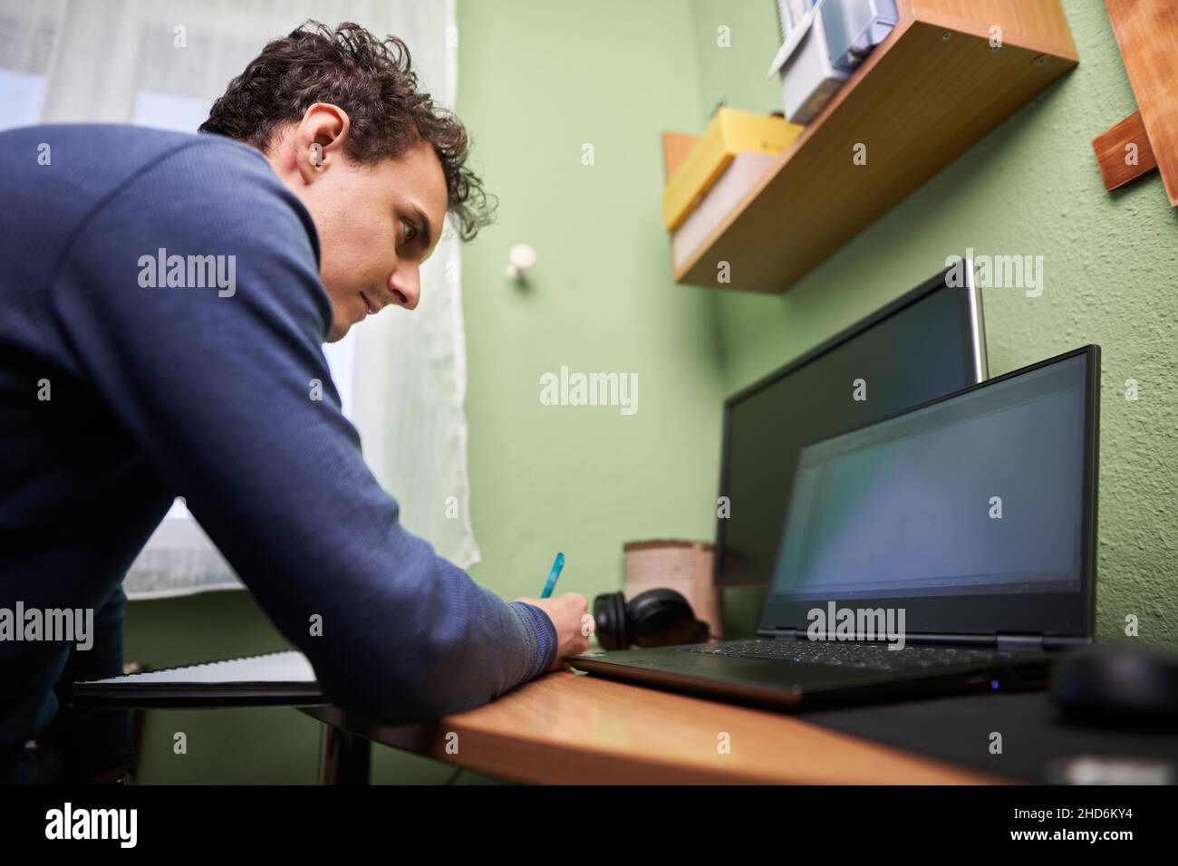 Software developer student working from home with laptop, computer ...
