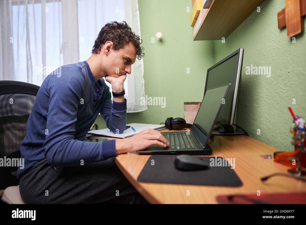 Software developer student working from home with laptop, computer ...