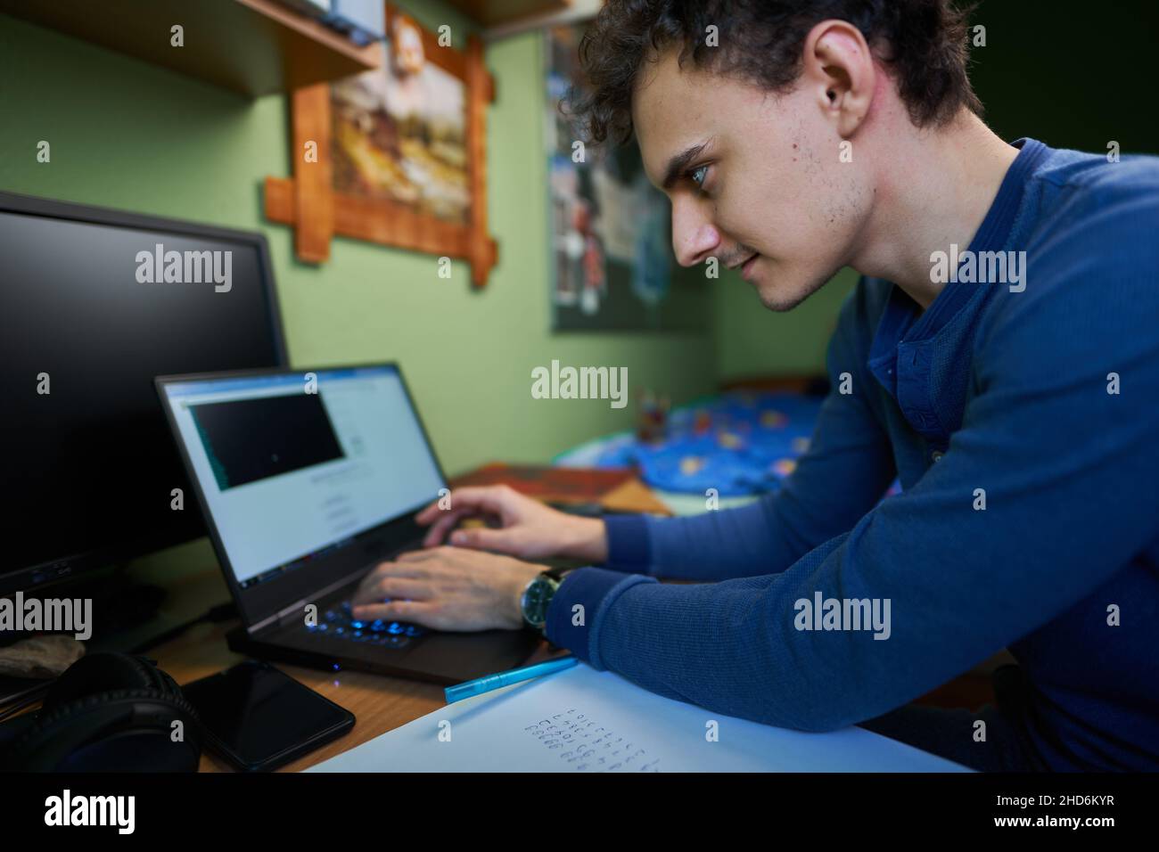 Software developer student working from home with laptop, computer ...