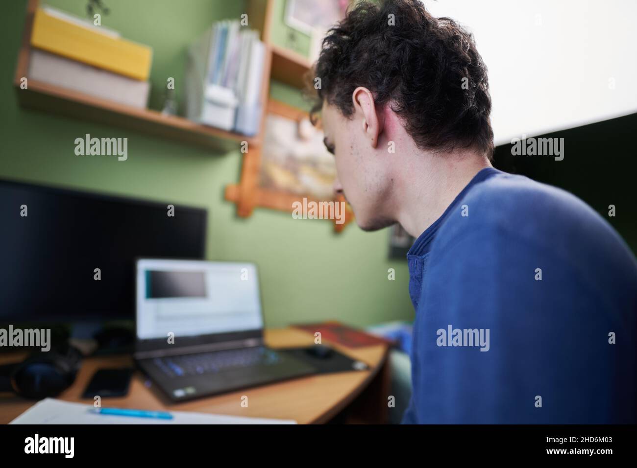 Software developer student working from home with laptop, computer ...