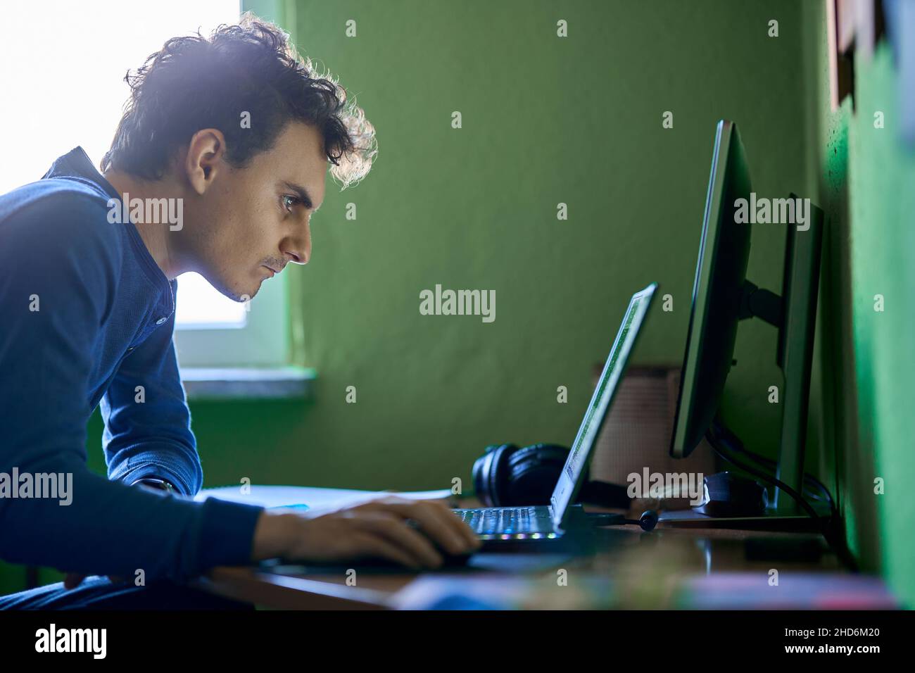 Software developer student working from home with laptop, computer ...