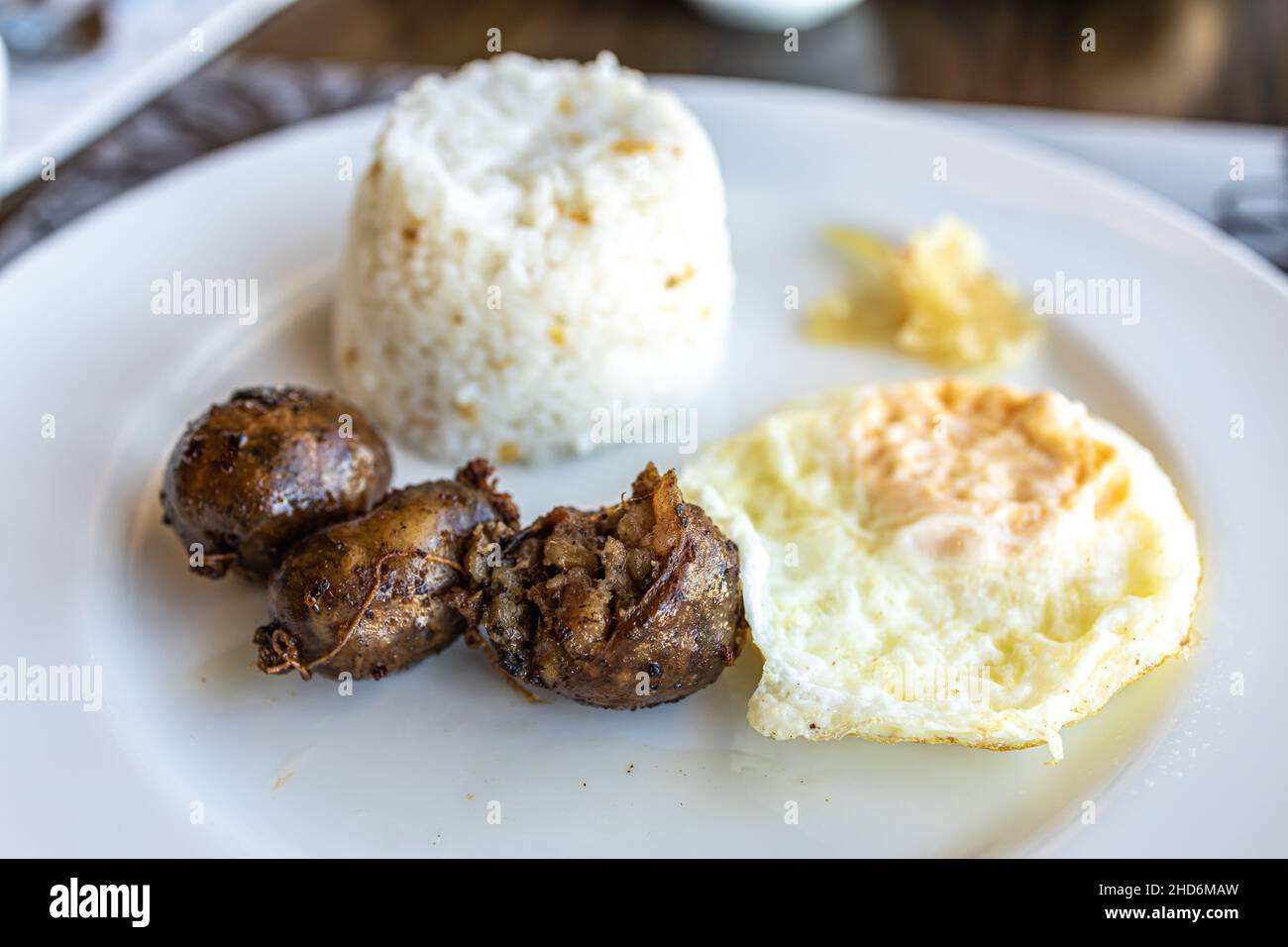 Filipino style breakfast Longsilog with rice and egg at Plate Stock ...