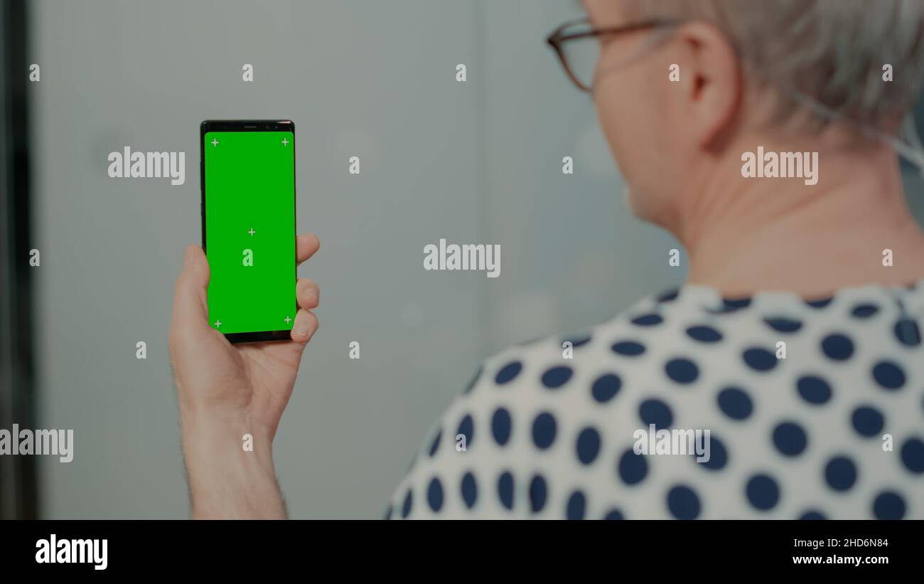Old patient holding green screen smartphone in hospital ward for ...