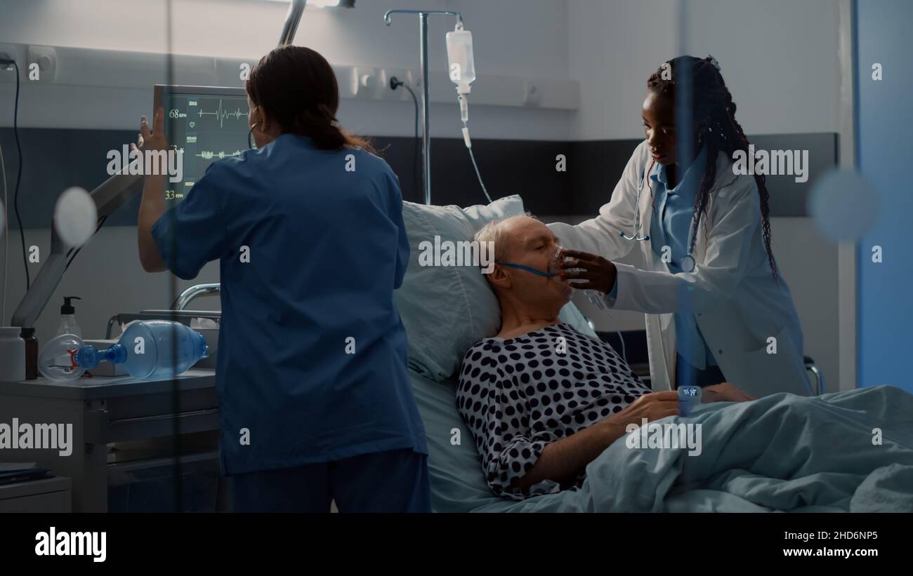 Patient with breathing problems in hospital ward bed needing ...