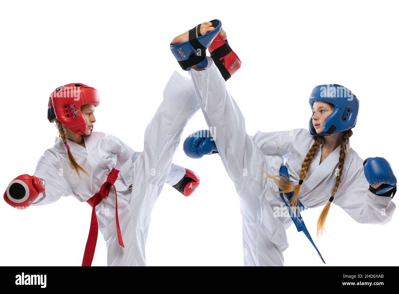 Sportive young girls, teens, taekwondo athletes training together ...