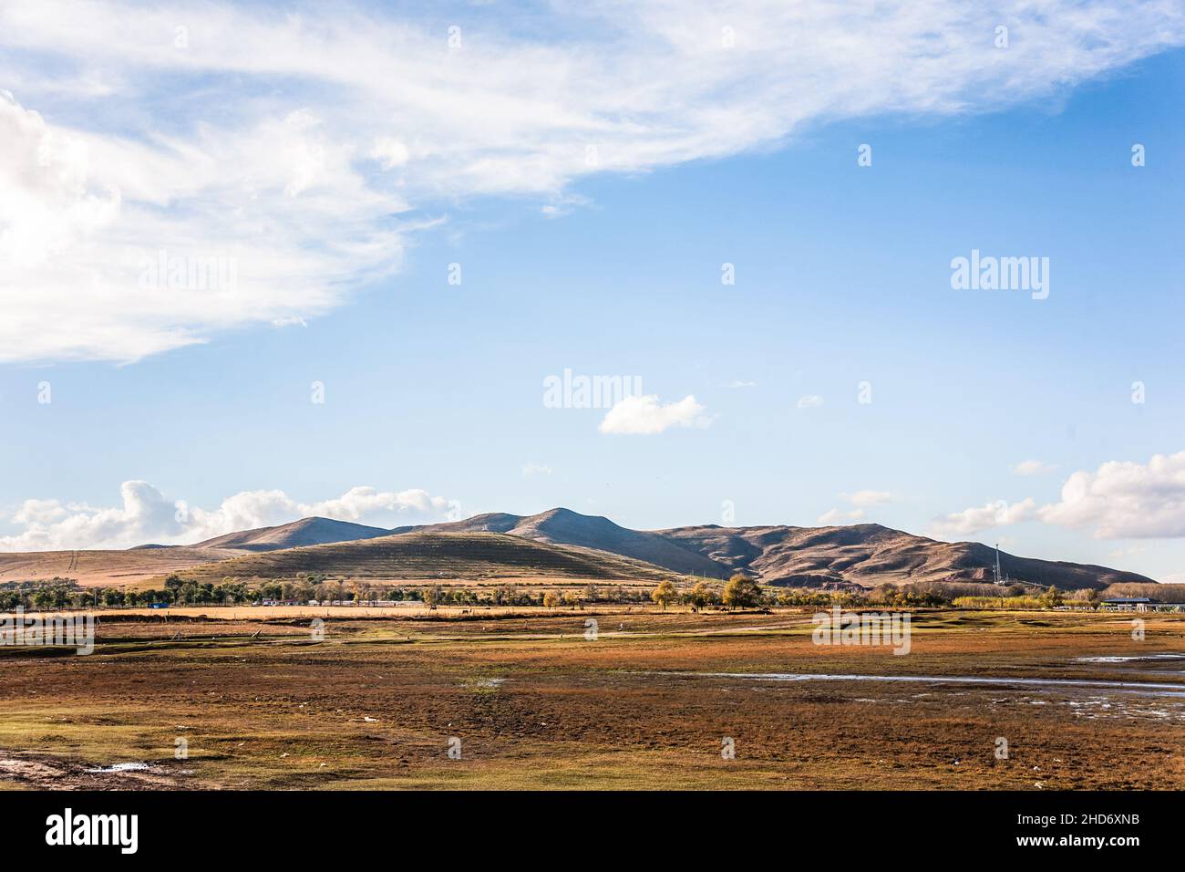 Wet ground in a field against a cloudy sky Stock Photo - Alamy