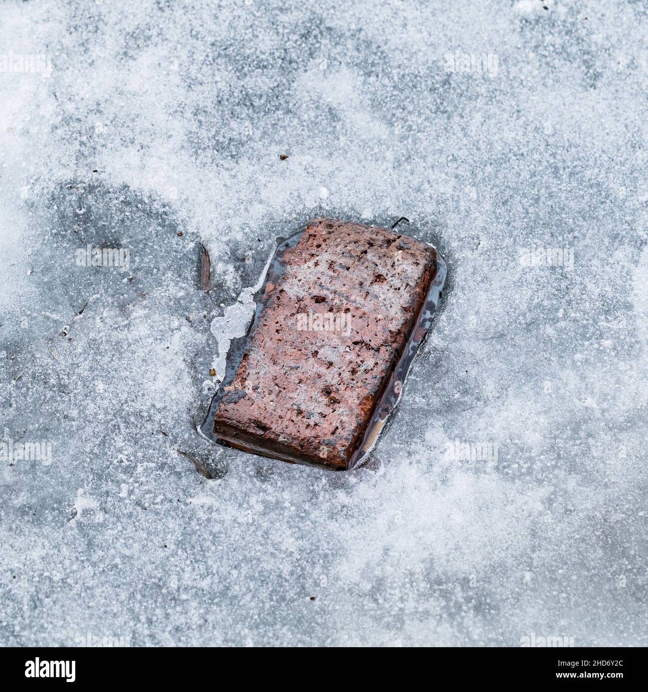 Brick on an iced lake Stock Photo - Alamy