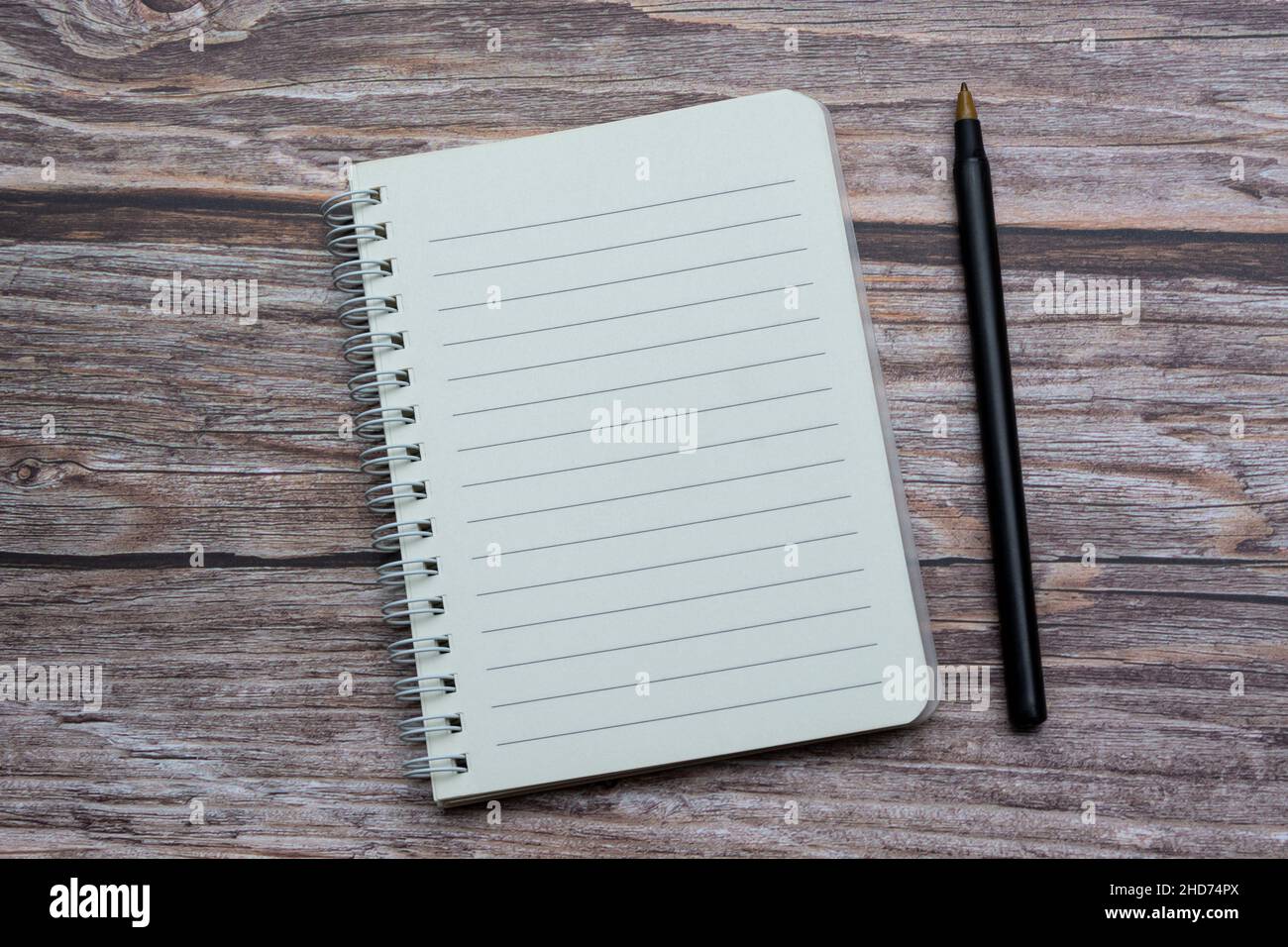 Notepad and pen on wooden table. Blank for text Stock Photo - Alamy