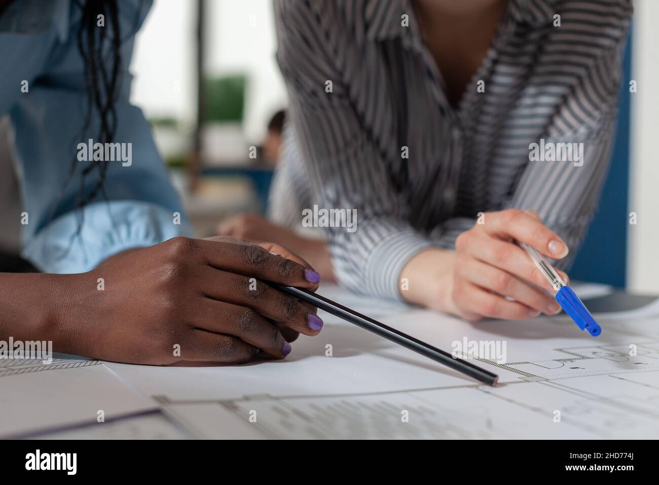 Closeup of architectural engineer hands holding pencil and pen over ...
