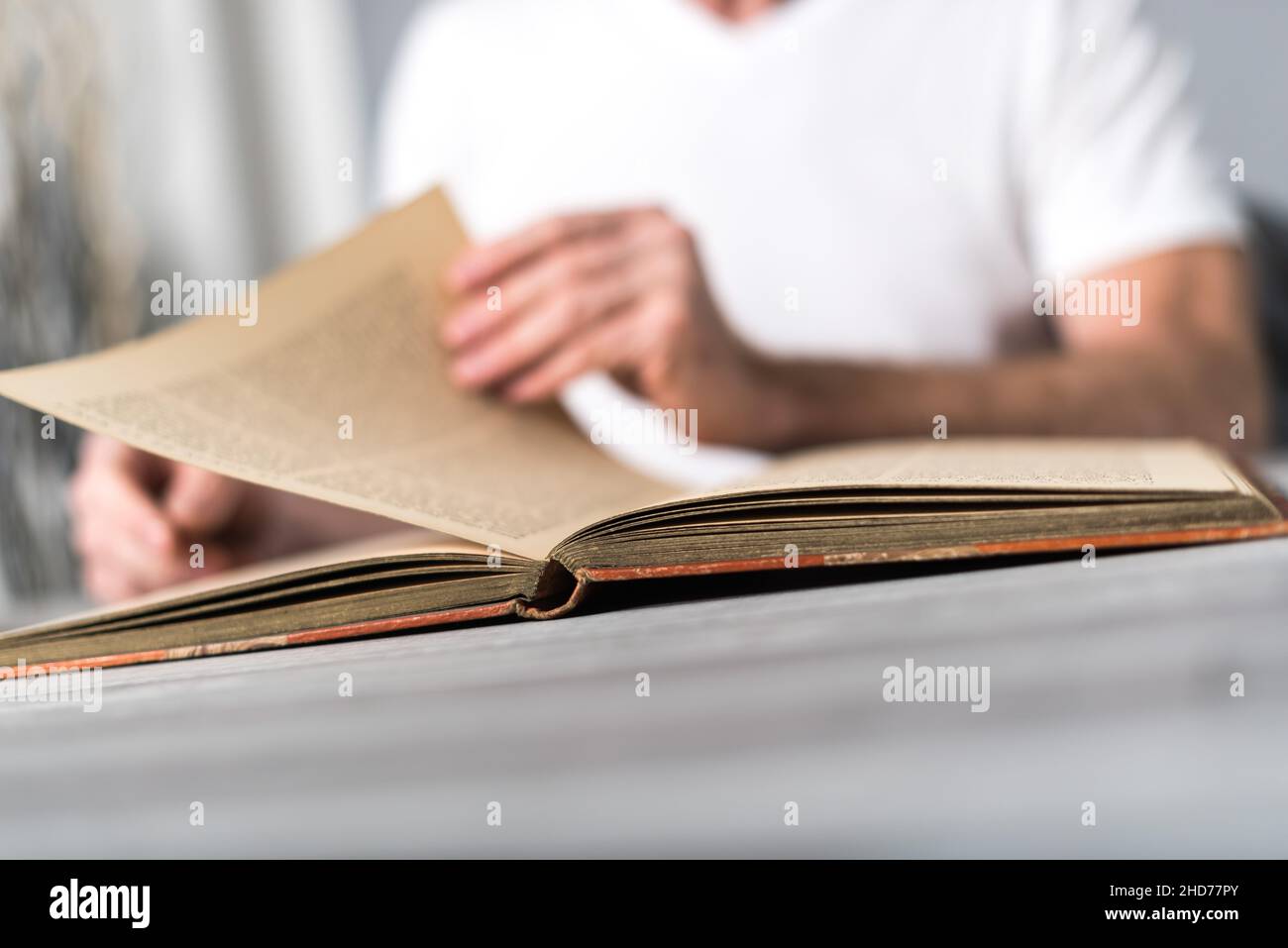 Man sitting reading a book Stock Photo - Alamy