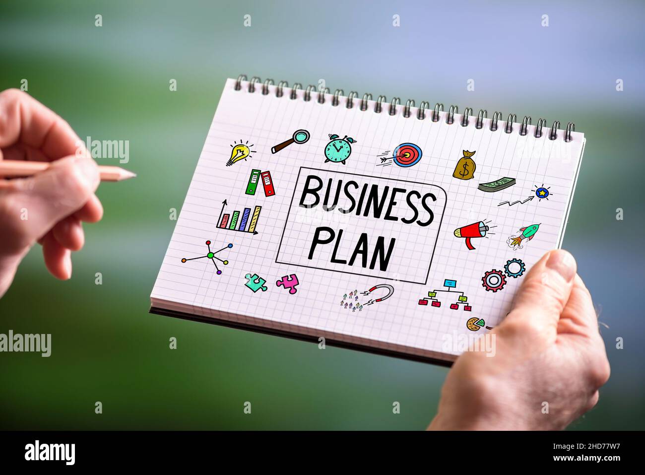 Hand drawing business plan concept on a notepad Stock Photo - Alamy