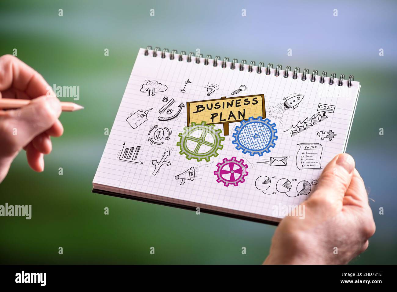 Hand drawing business plan concept on a notepad Stock Photo - Alamy