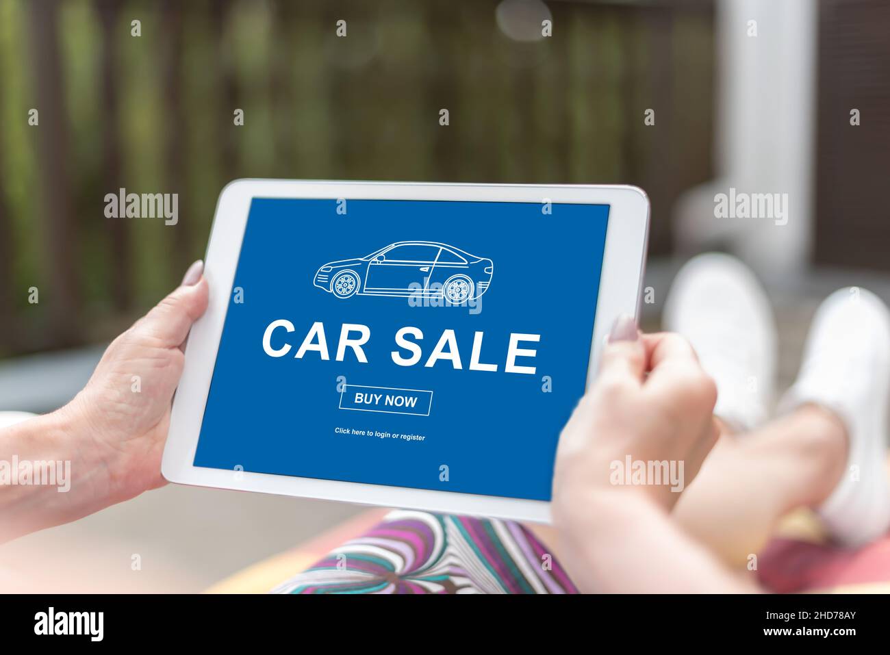 Female hands holding a tablet with car sale concept Stock Photo - Alamy