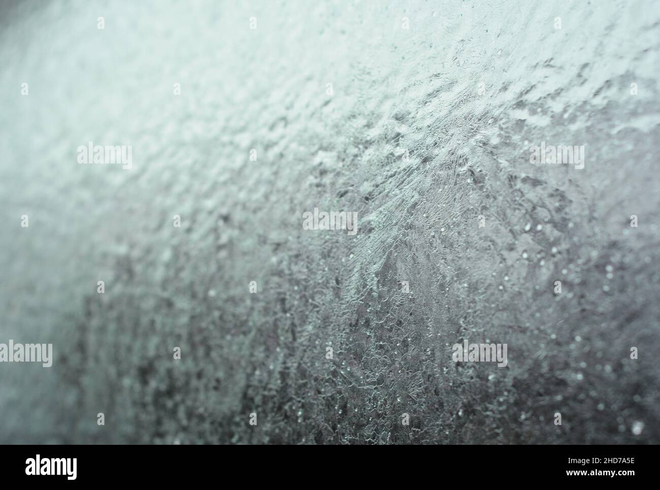 Frozen car window, frozen glass texture. A car window covered with ice ...