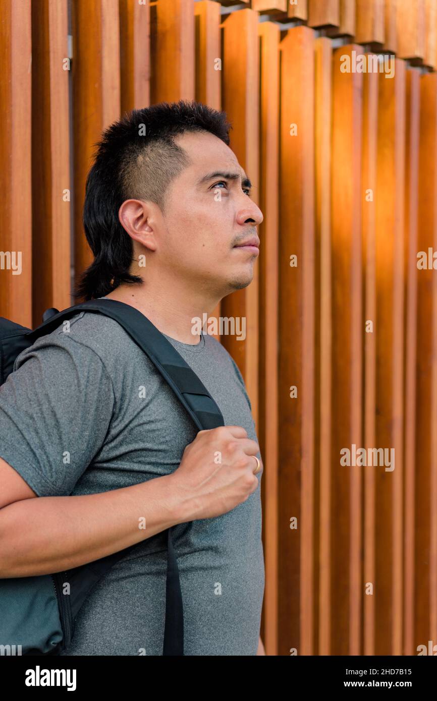 young indigenous man walking with a backpack Stock Photo - Alamy