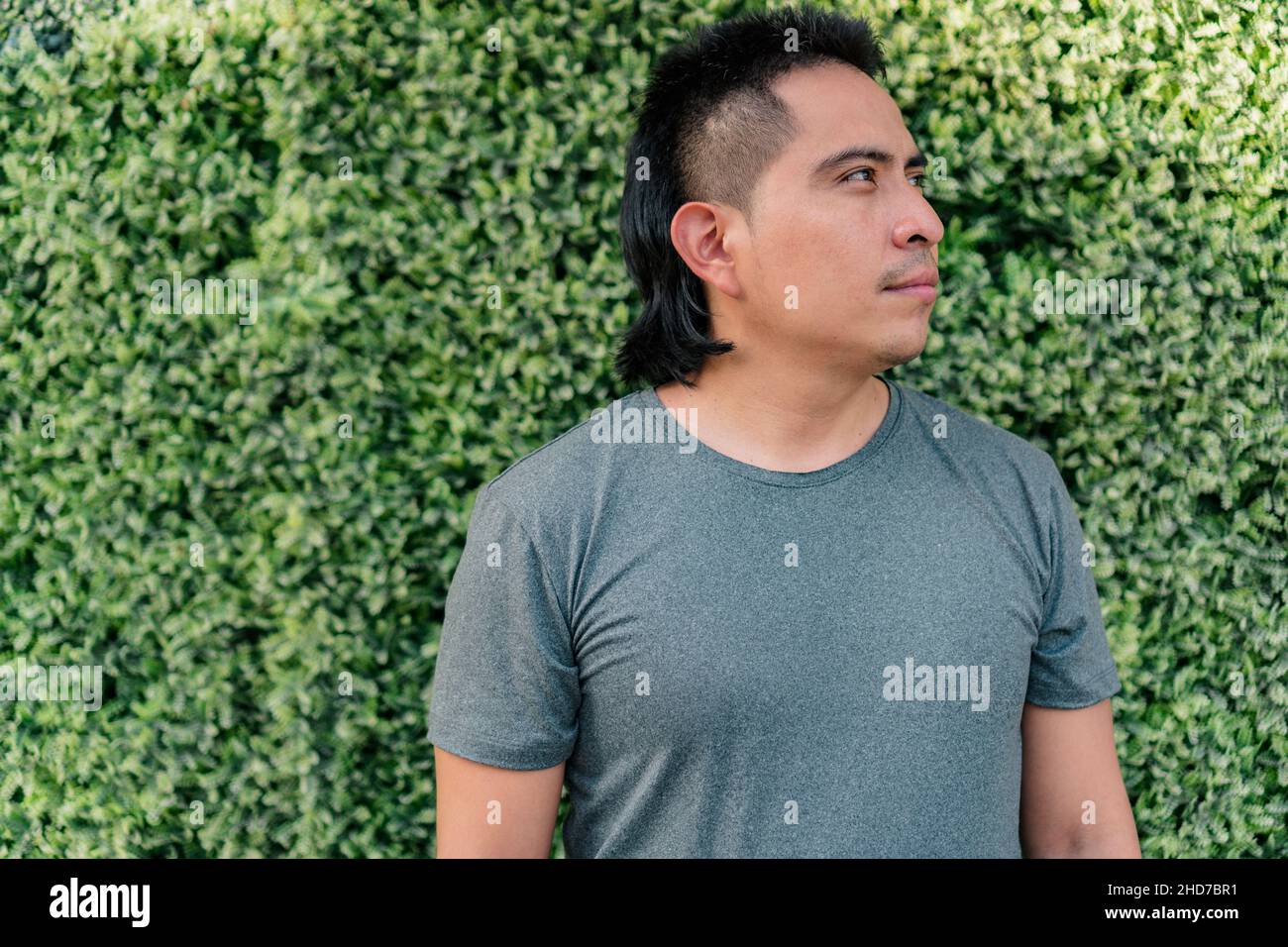 Young Indigenous Colombian man looking away, outside Stock Photo - Alamy