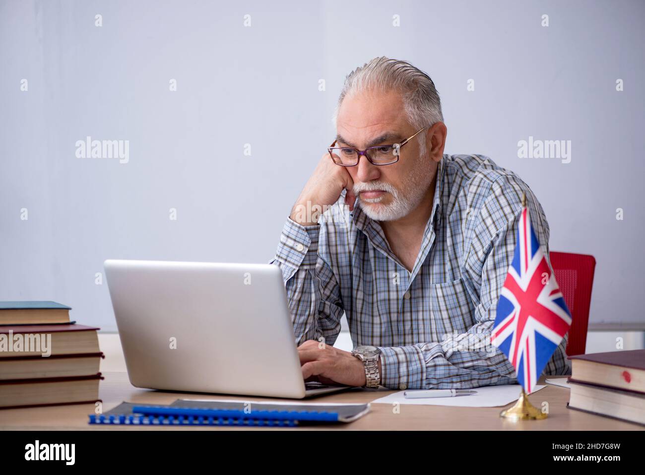 Aged english language teacher in the classroom Stock Photo - Alamy