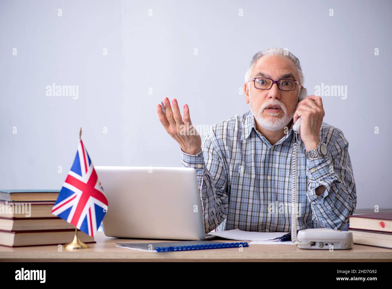 Aged english language teacher in the classroom Stock Photo - Alamy