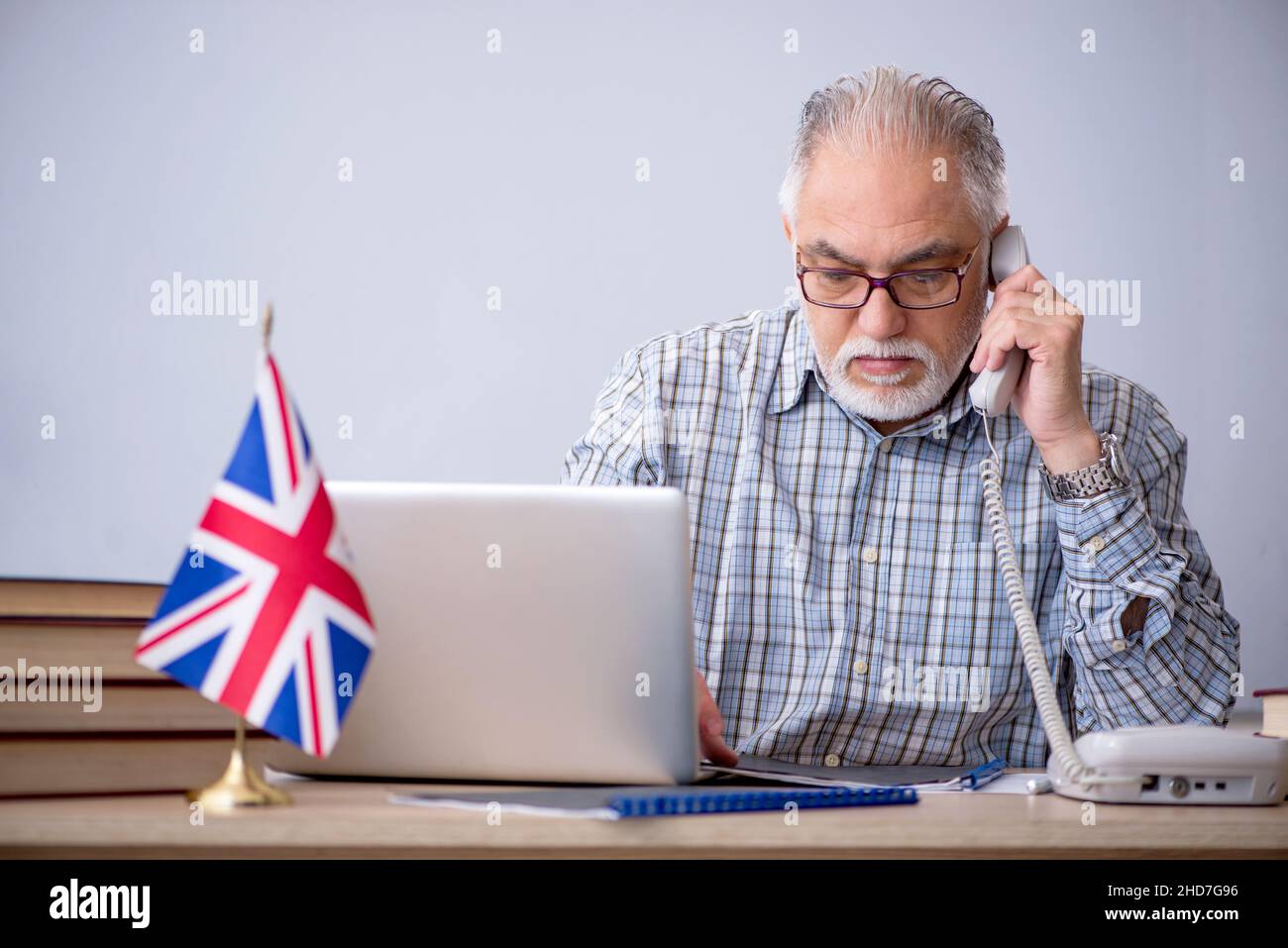 Aged english language teacher in the classroom Stock Photo - Alamy
