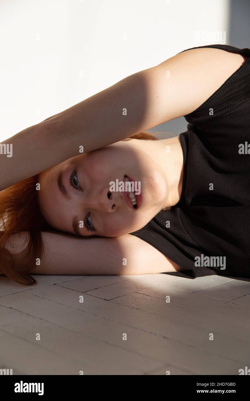 Young european woman with white skin on the floor portrait with red ...