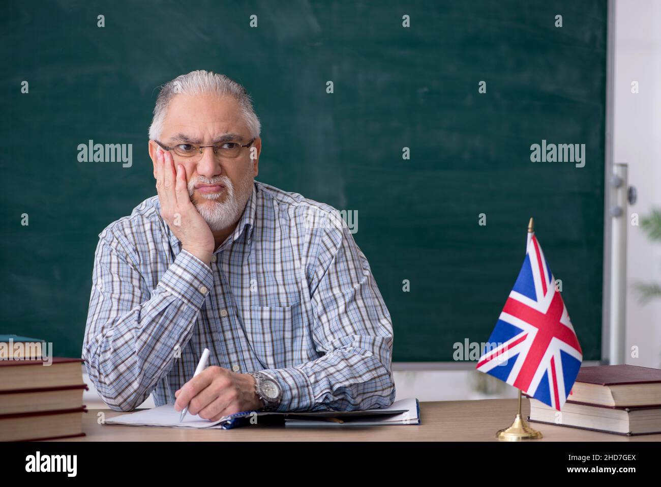 Aged english language teacher in the classroom Stock Photo - Alamy