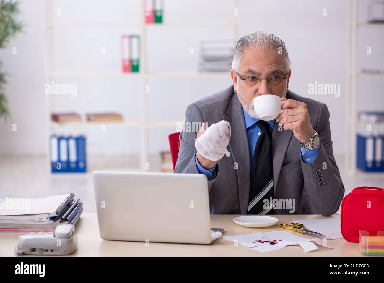 Old businessman employee cutting his hand at workplace Stock Photo - Alamy