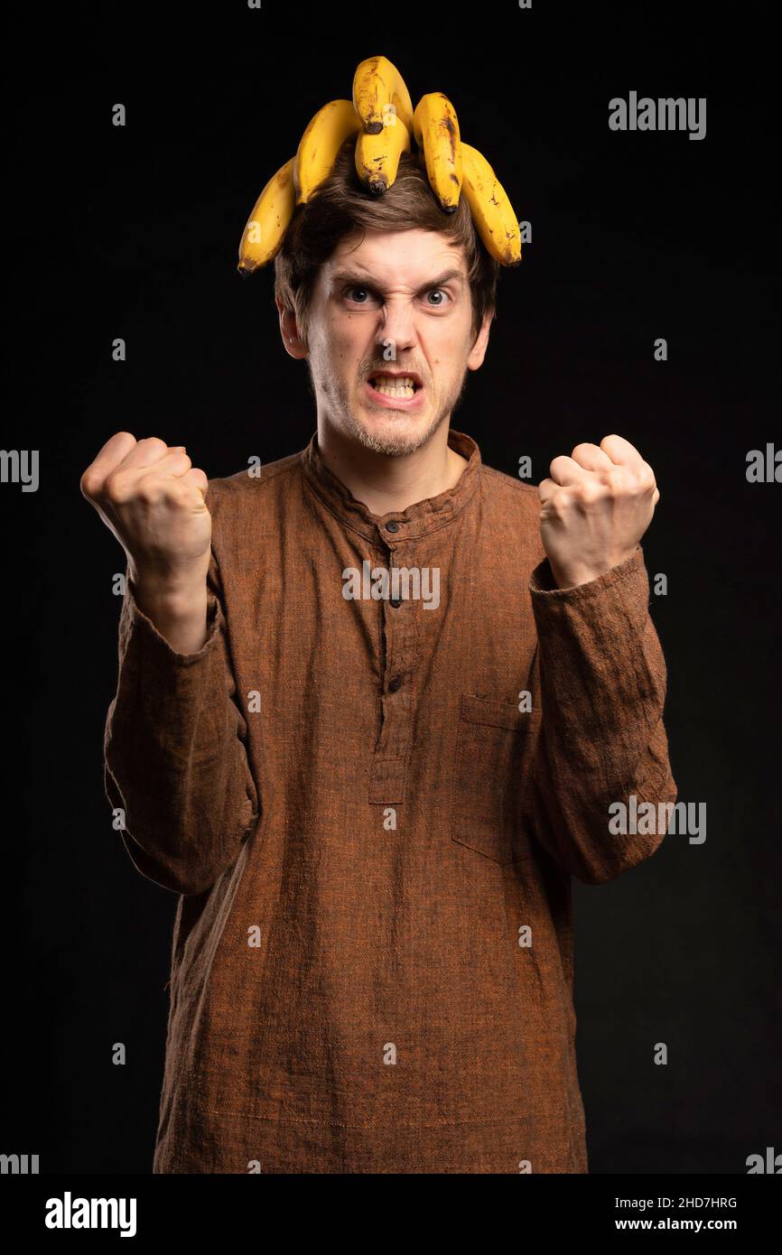Young handsome tall slim white man with brown hair bananas on head ...