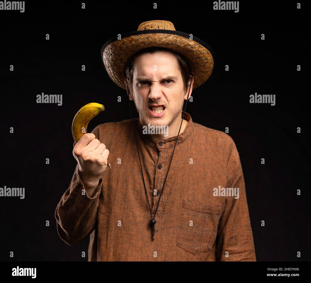 Young handsome tall slim white man with brown hair holding banana ...