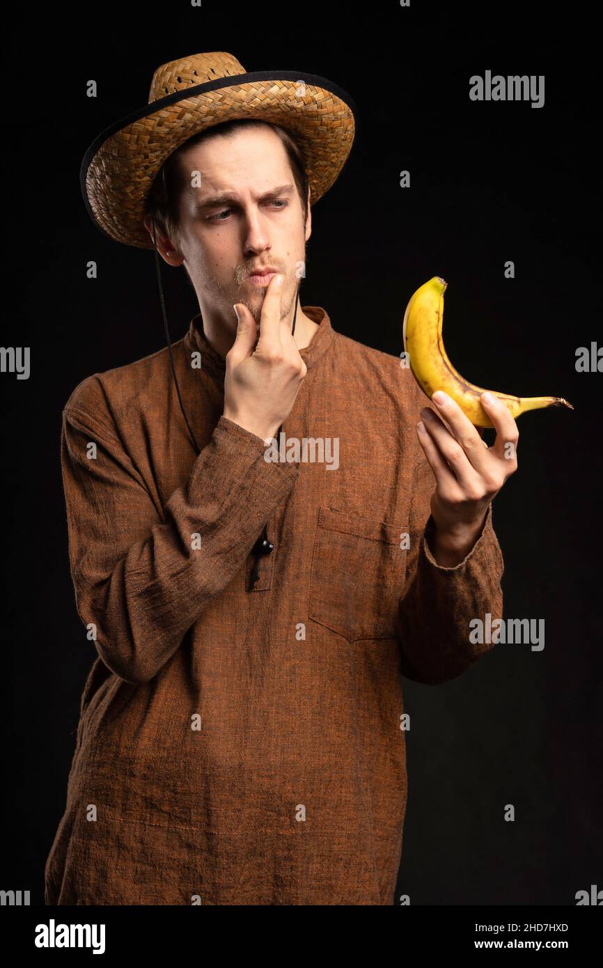 Young handsome tall slim white man with brown hair thinking holding ...