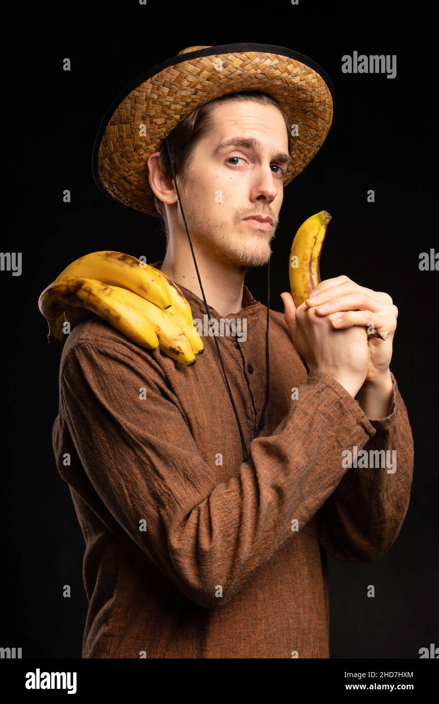 Young handsome tall slim white man with brown hair bananas on shoulder ...