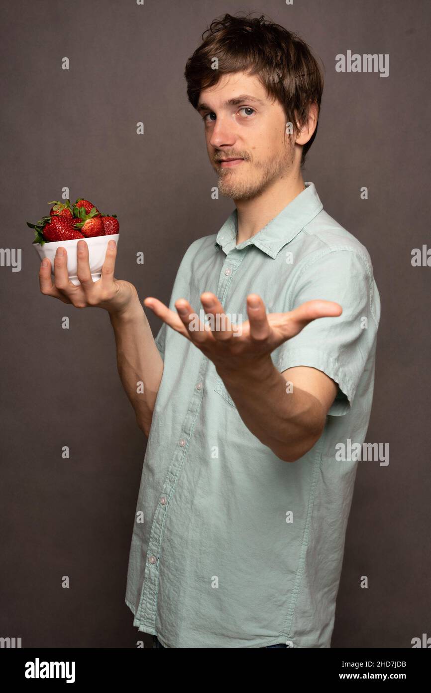 Young handsome tall slim white man with brown hair offering you hand ...
