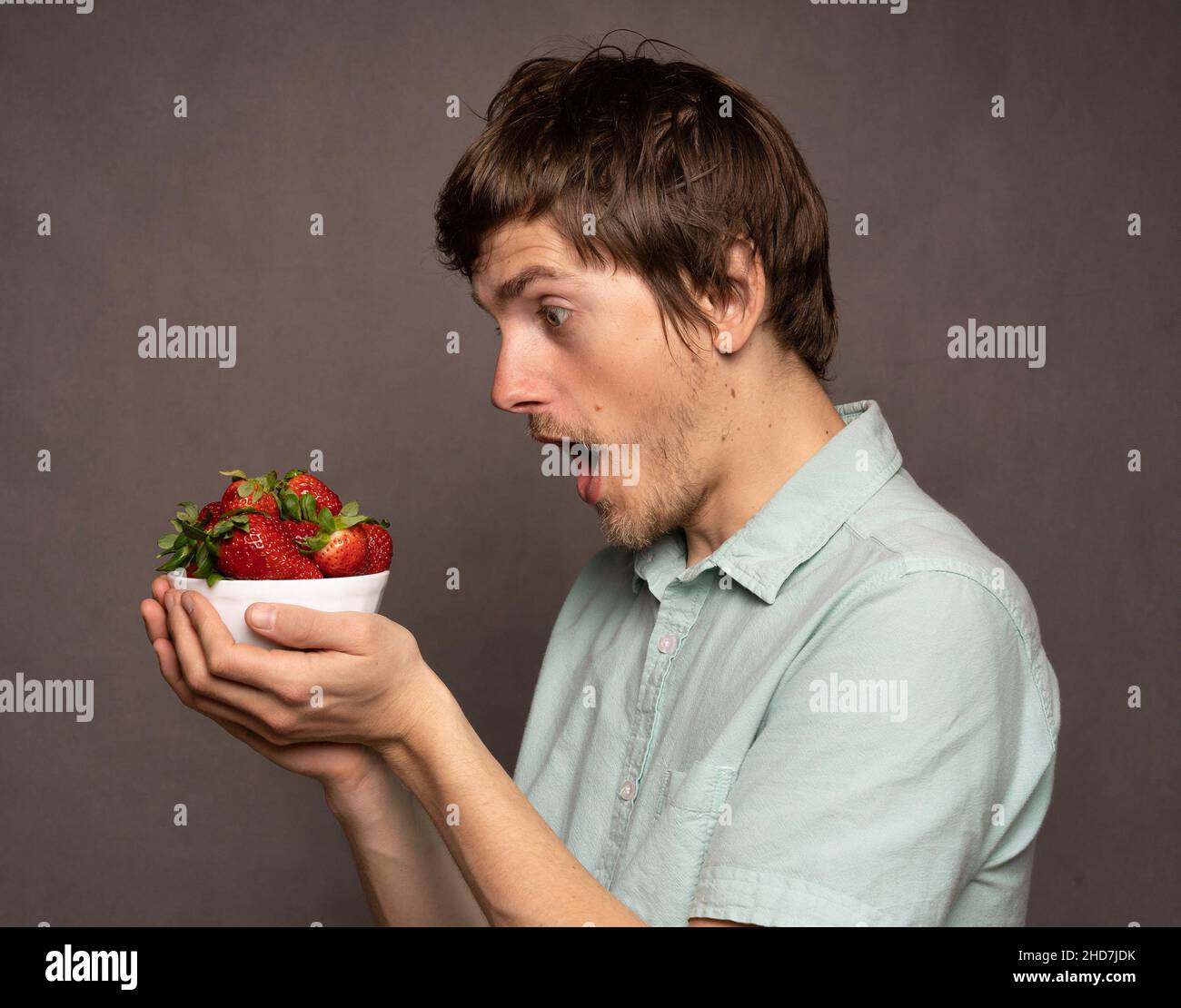Young handsome tall slim white man with brown hair wowed by ...