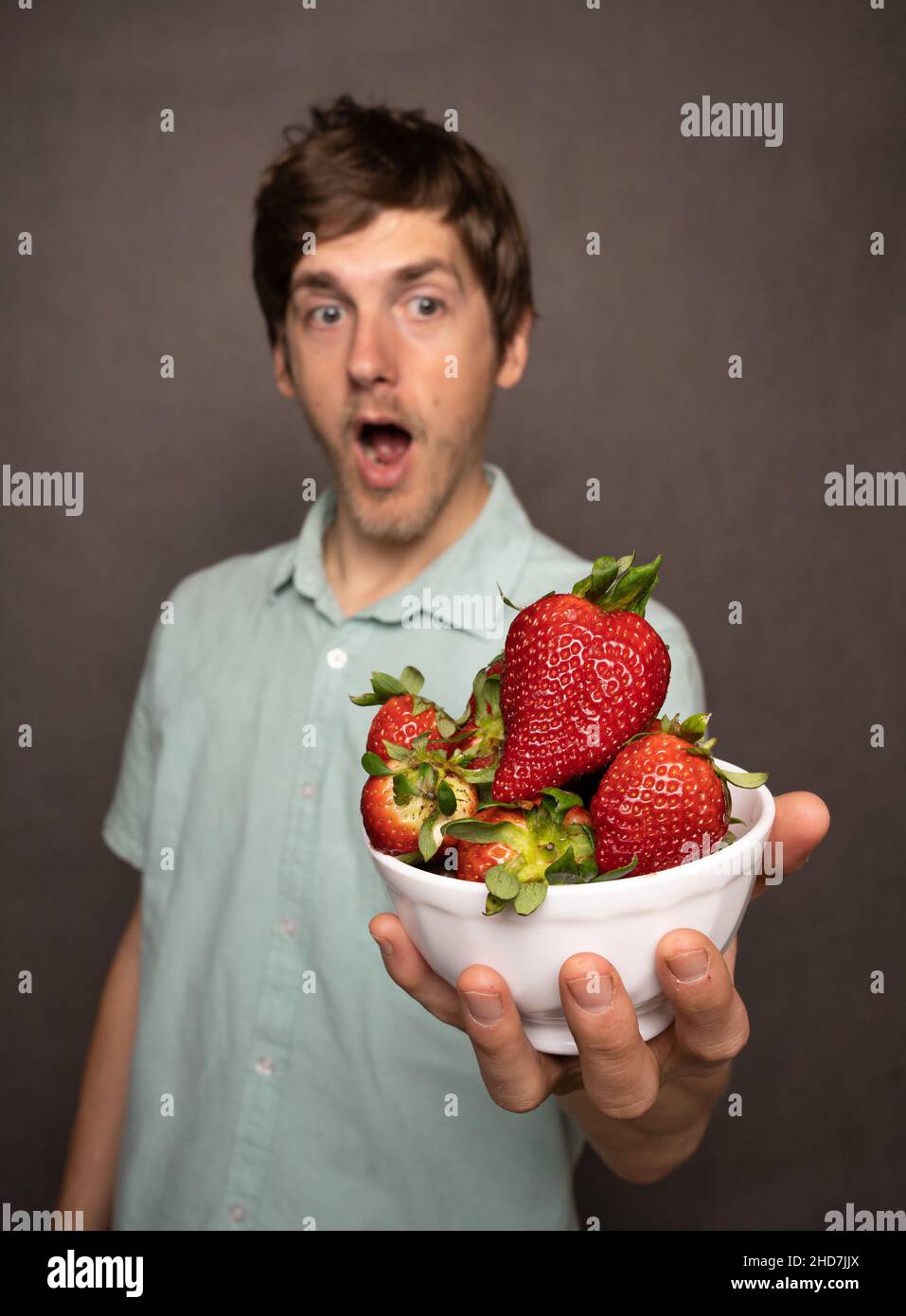 Young handsome tall slim white man with brown hair offering ...