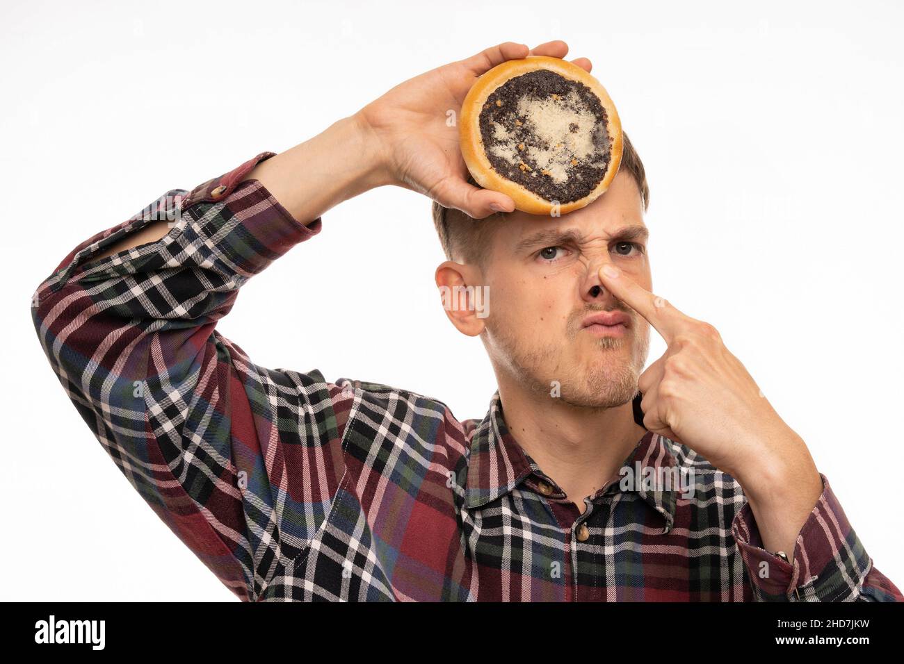 Young handsome tall slim white man with brown hair holding his nose ...