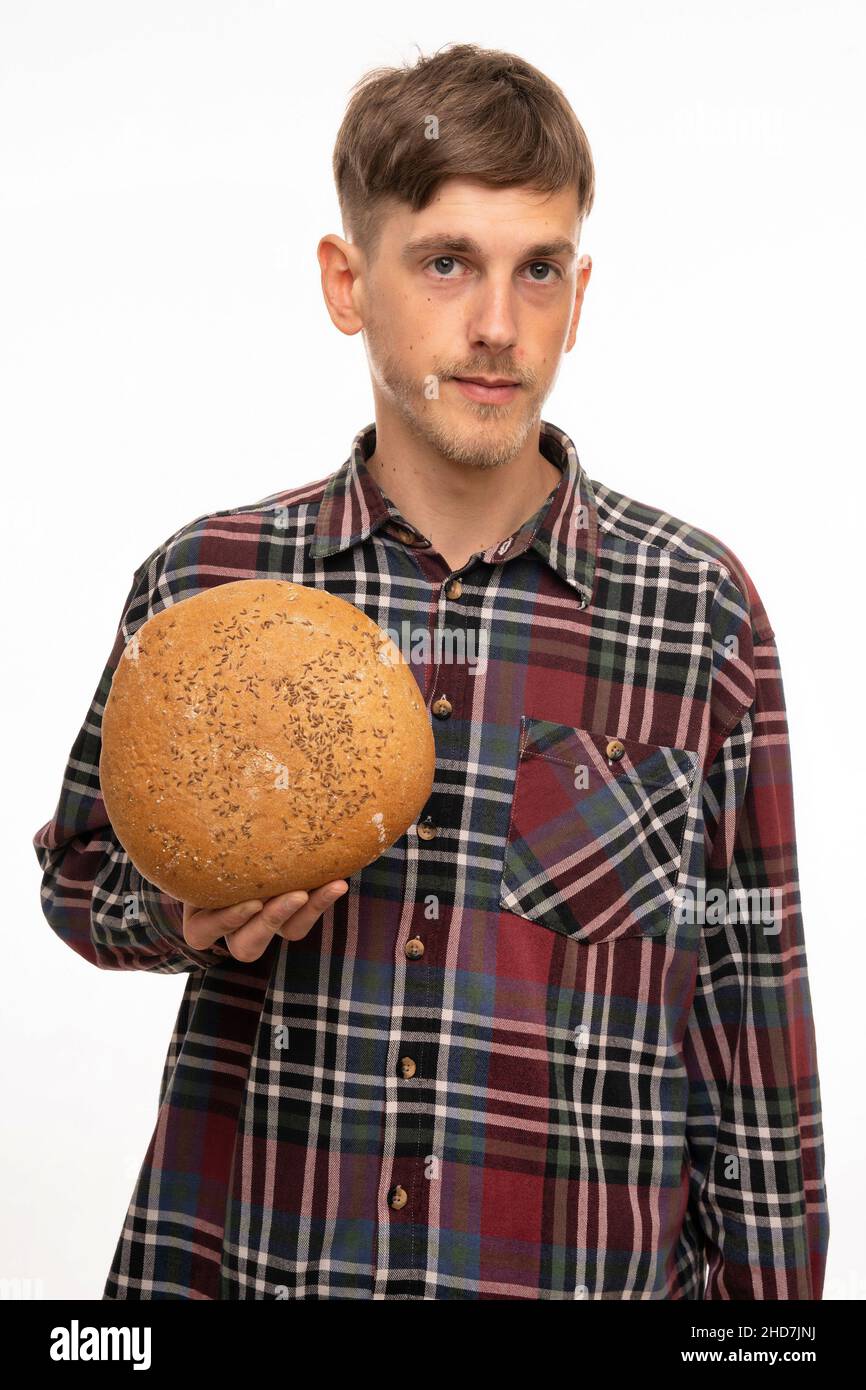 Young handsome tall slim white man with brown hair holding loaf of ...