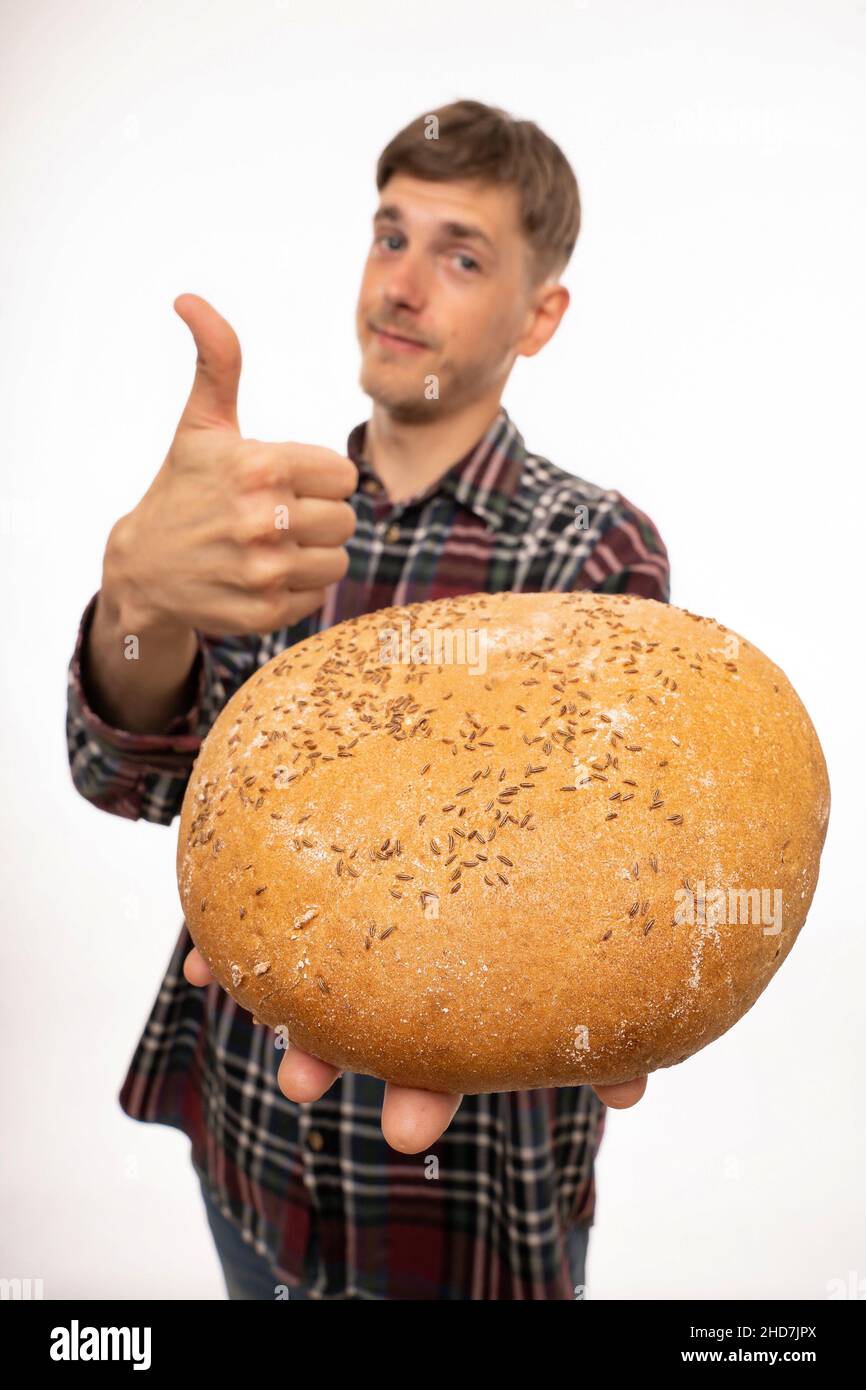 Young handsome tall slim white man with brown hair offering you bread ...