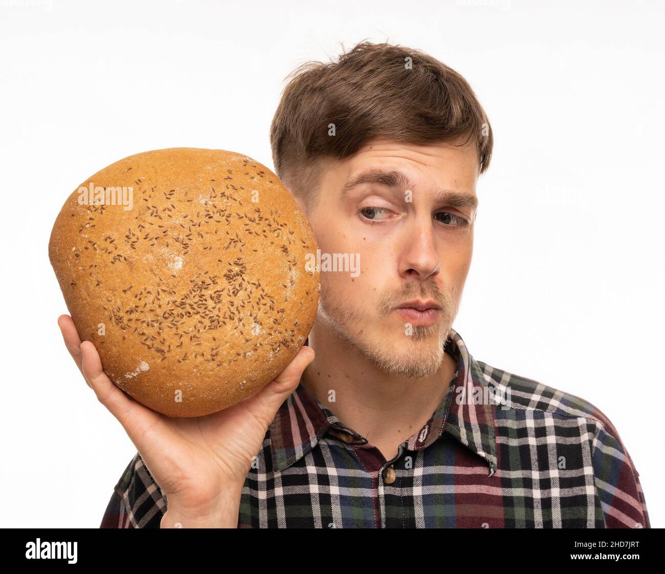 Young handsome tall slim white man with brown hair holding bread next ...