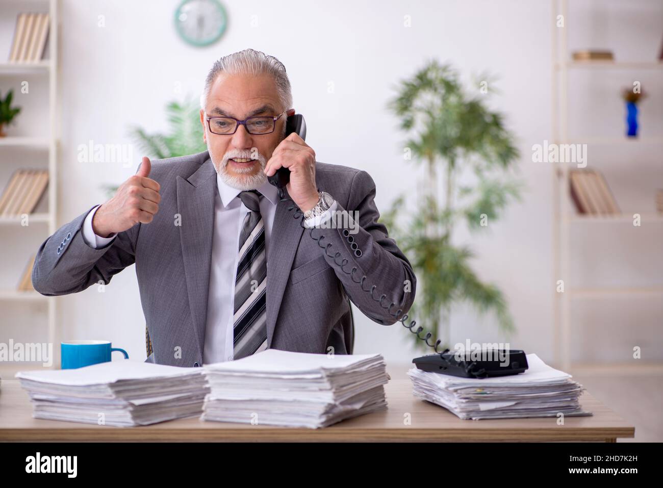 Old businessman employee and too much work at workplace Stock Photo - Alamy