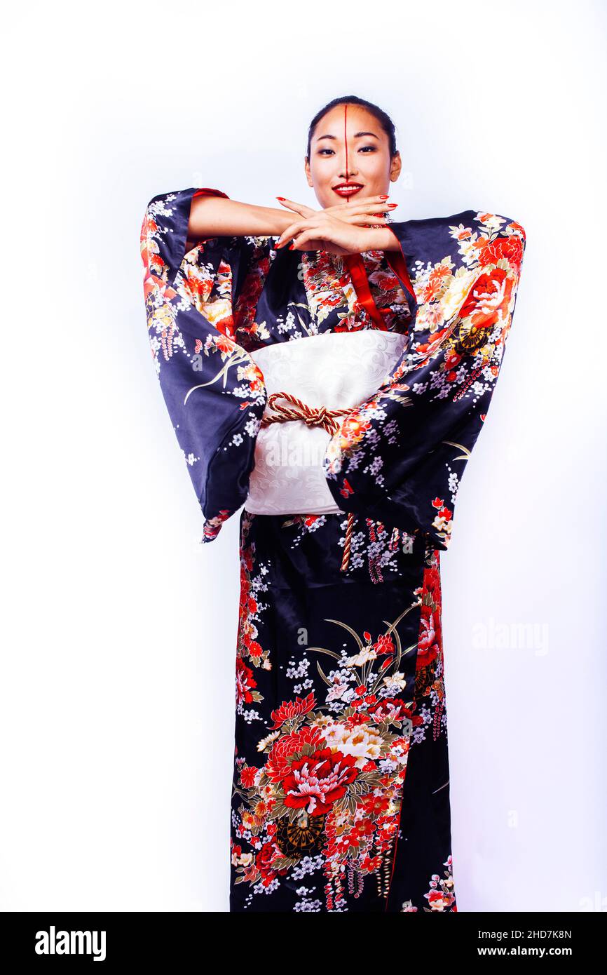 young pretty geisha in black kimono posing isolated on white background ...