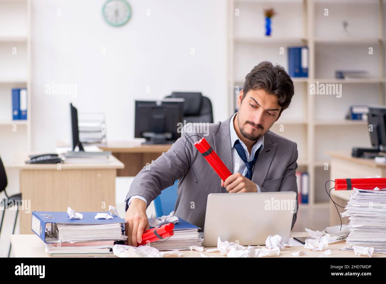 Young employee and too much work in the office Stock Photo - Alamy