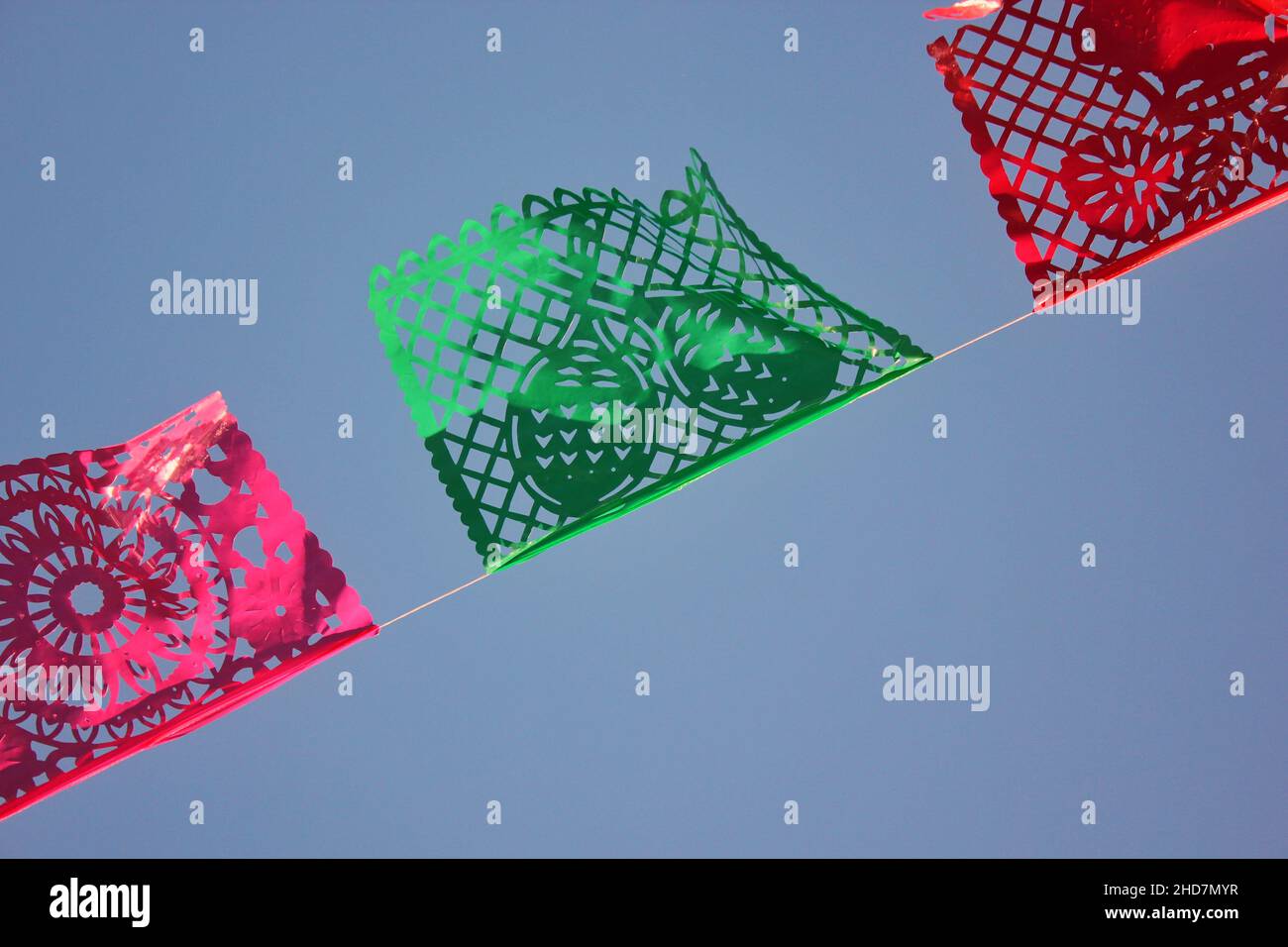 Green banner flapping in the breeze against the clear blue sky Stock ...